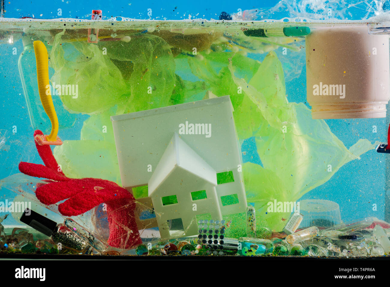 Polluted water. White plastic kid house lying on the bottom with ...