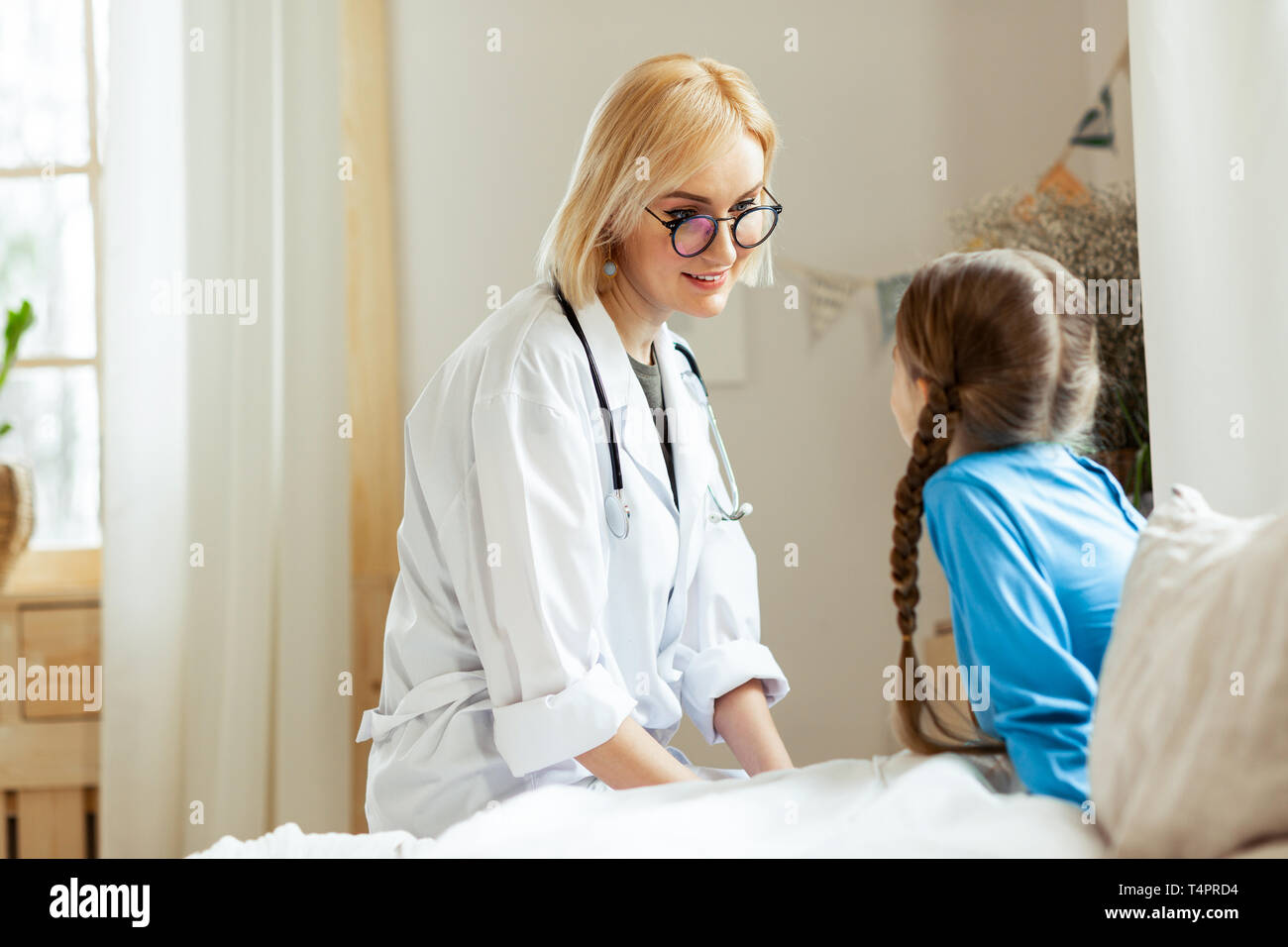 Conversation between doctor and patient. Smiling beaming appealing fair ...
