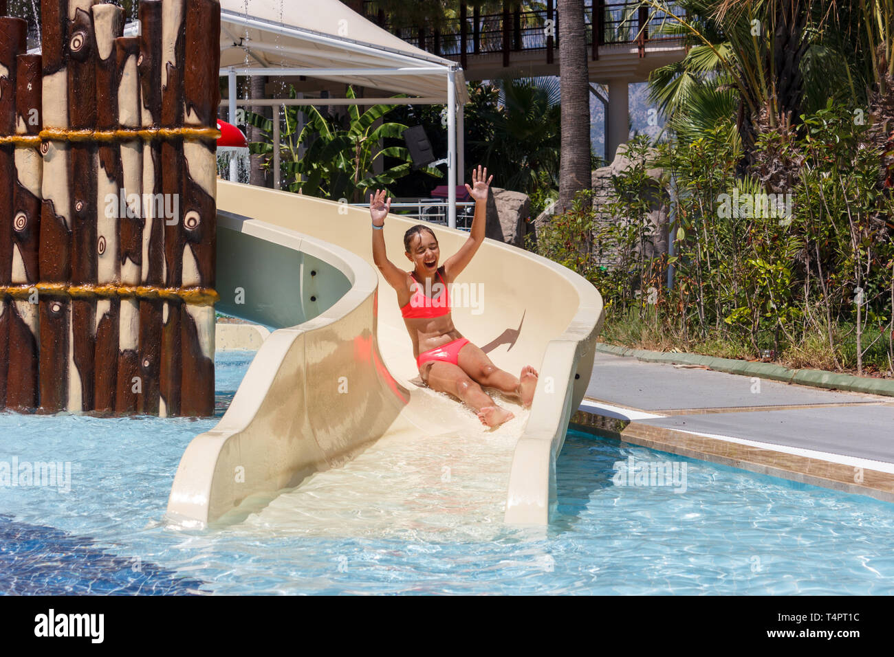 Joyful Laughing Teen Girl Slides Off The Water Slide In Hotel Aquapark