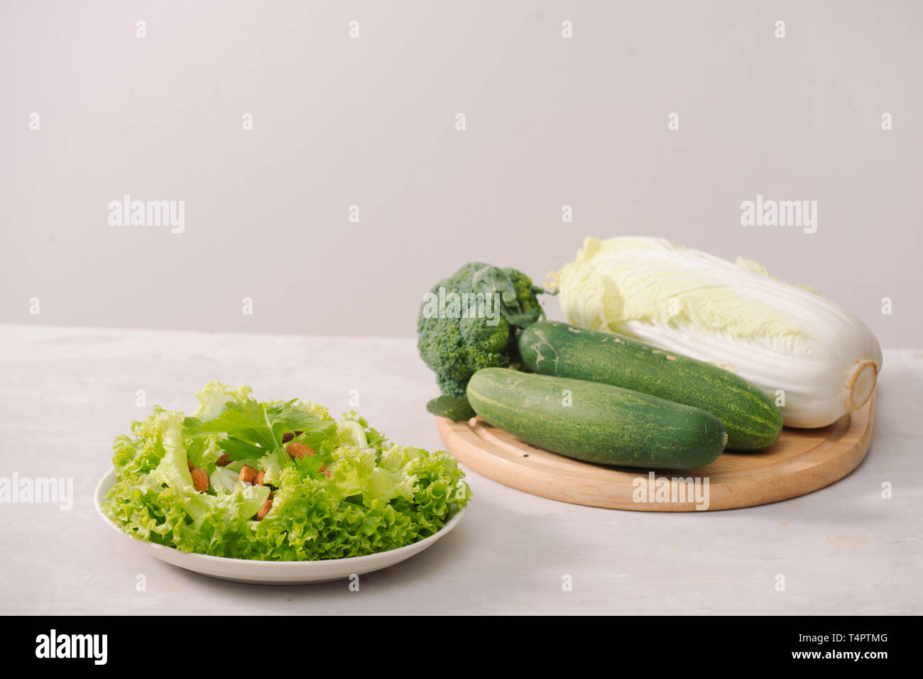 Various green organic salad ingredients on white background. Healthy ...
