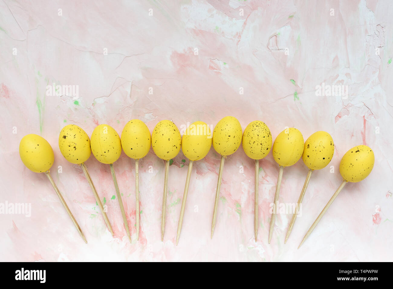 Easter wooden sticks for finger food on a pink background. Easter party ...