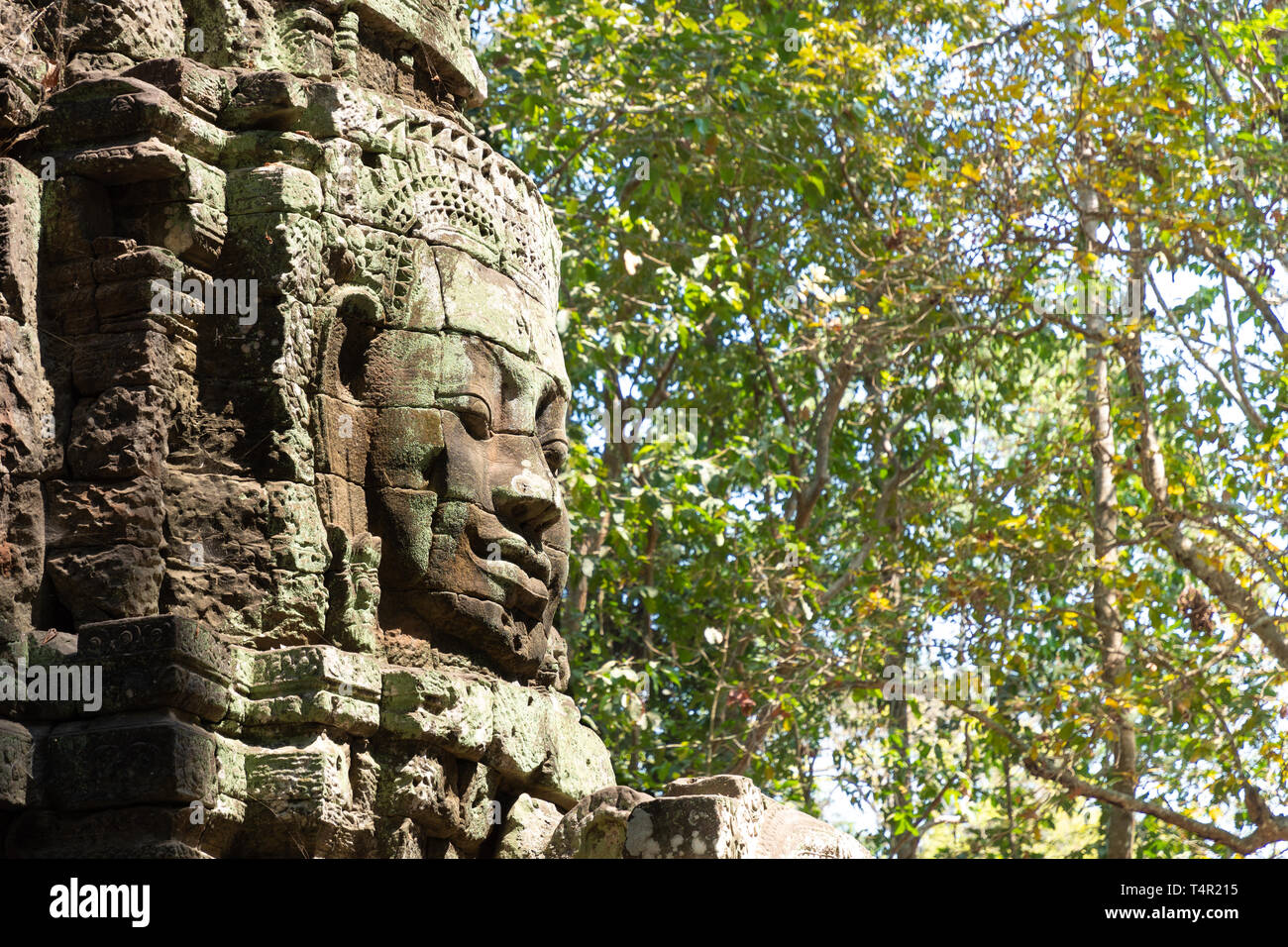 Large carved human face on tower at entrance to Ta Som temple in Angkor ...