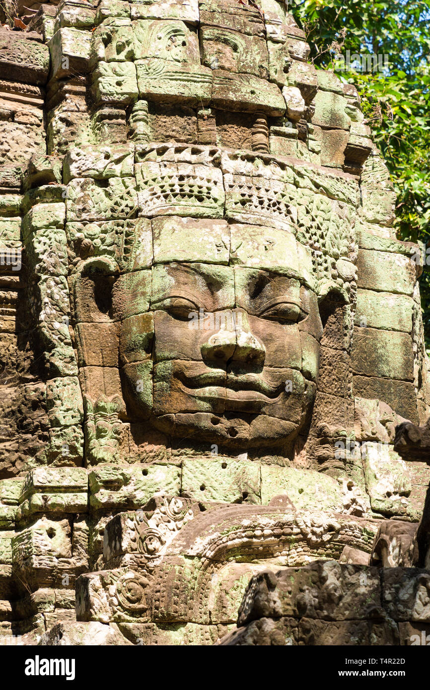 Large carved human face on tower at entrance to Ta Som temple in Angkor ...