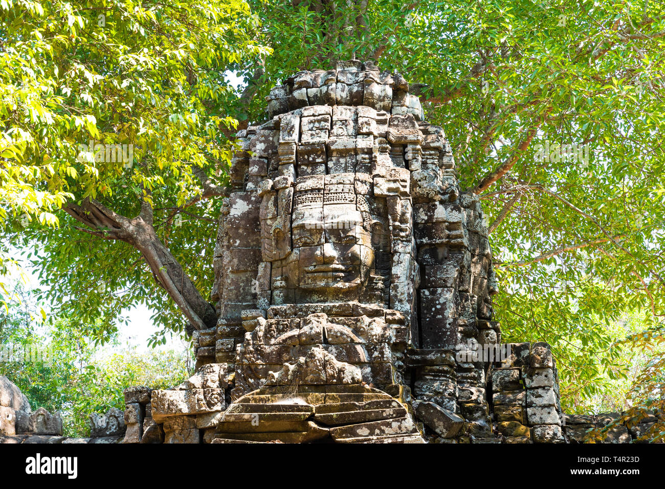 Large carved human face on tower at entrance to Ta Som temple in Angkor ...