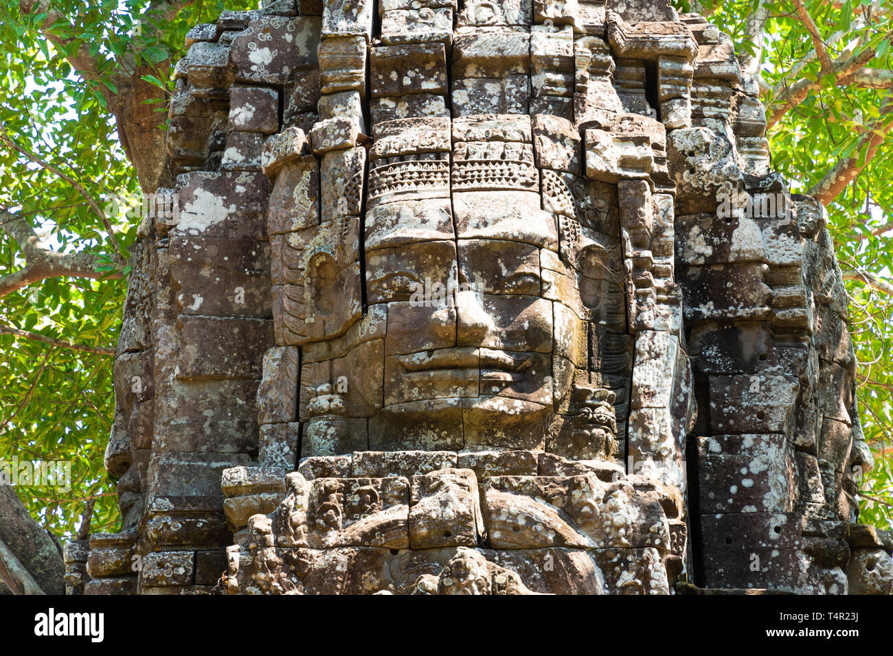 Large carved human face on tower at entrance to Ta Som temple in Angkor ...
