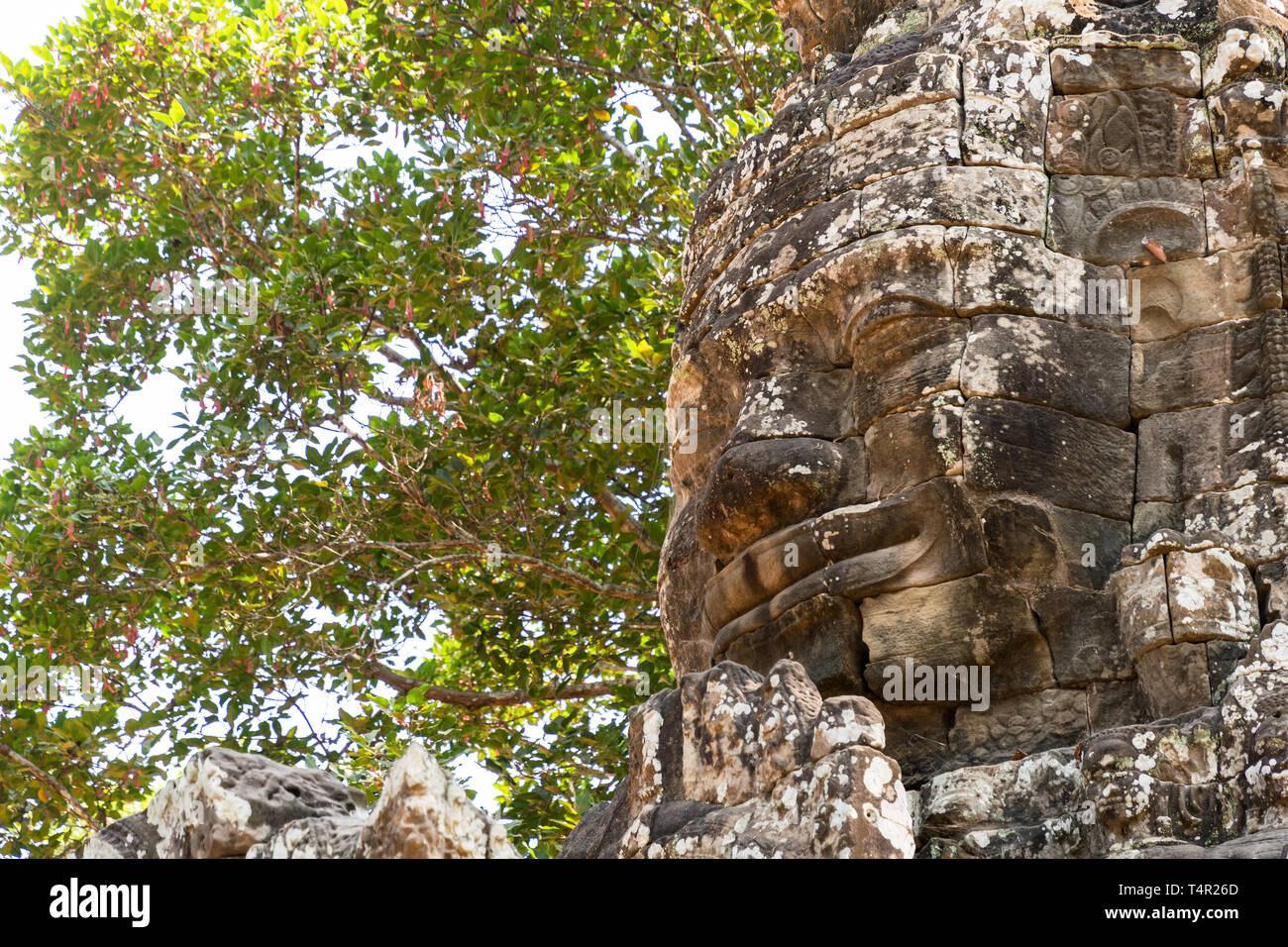 Large carved human face on tower at entrance to East Mebon temple in ...