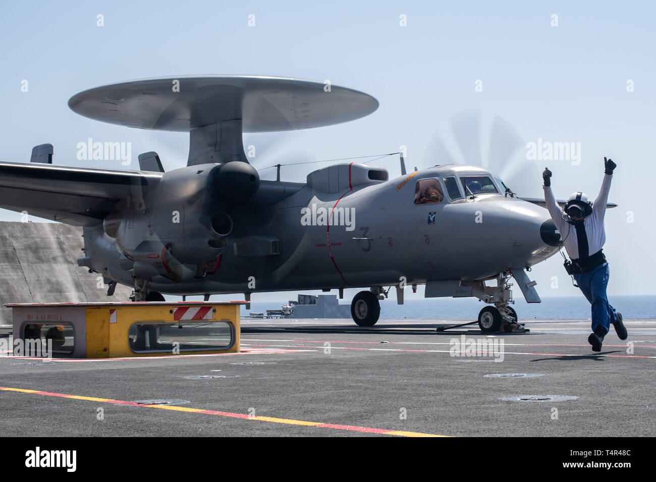 A French Marine Nationale Sailor signals that a French Marine Nationale ...