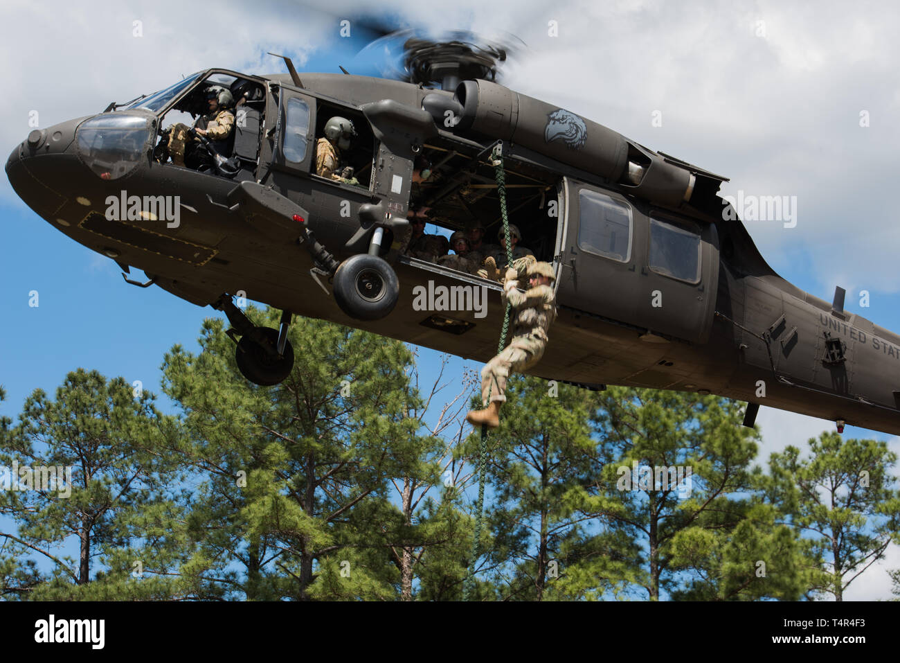 U.S. Army Rangers fast rope from a helicopter in preparation for the ...