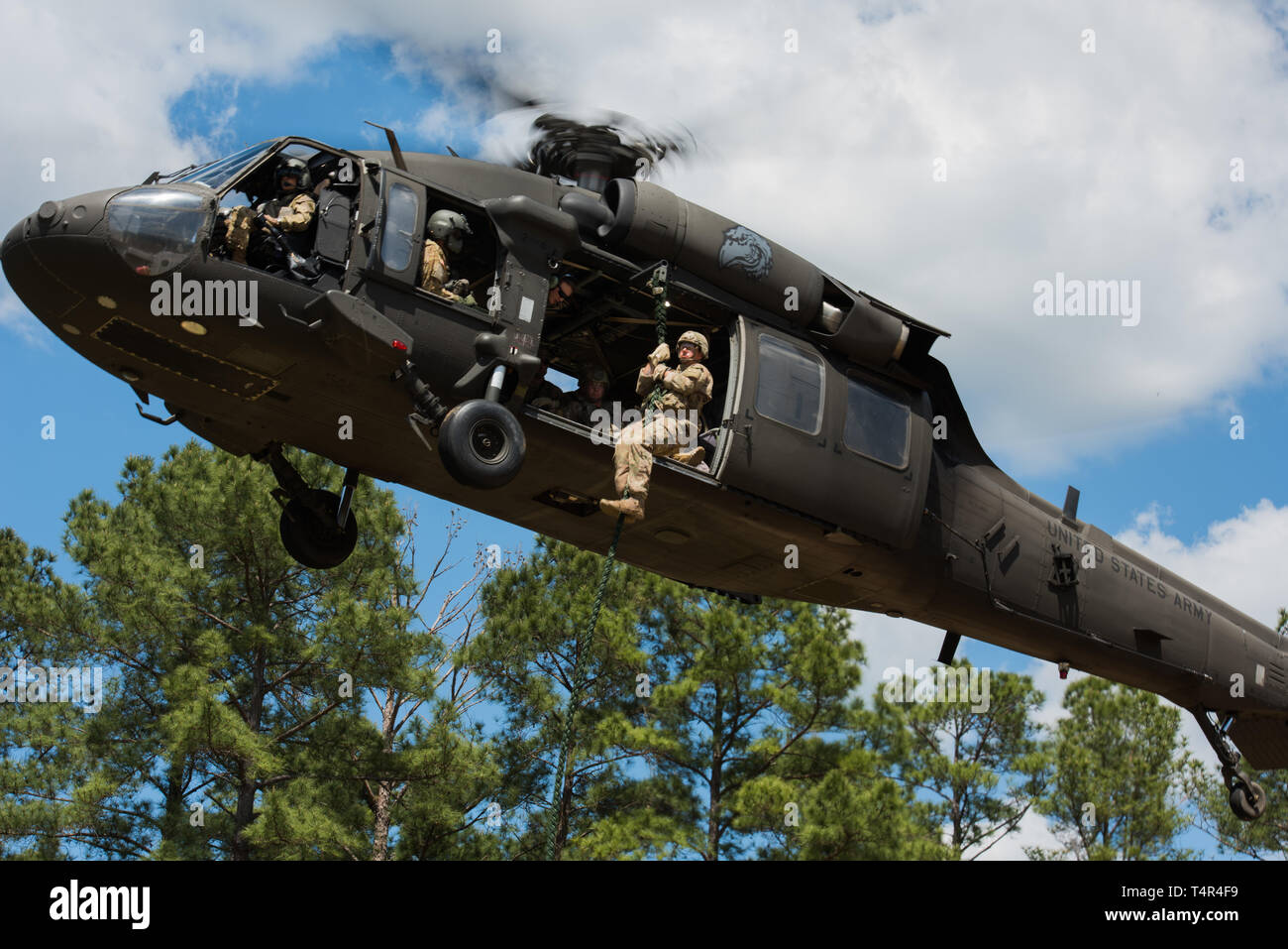 U.S. Army Rangers fast rope from a helicopter in preparation for the ...