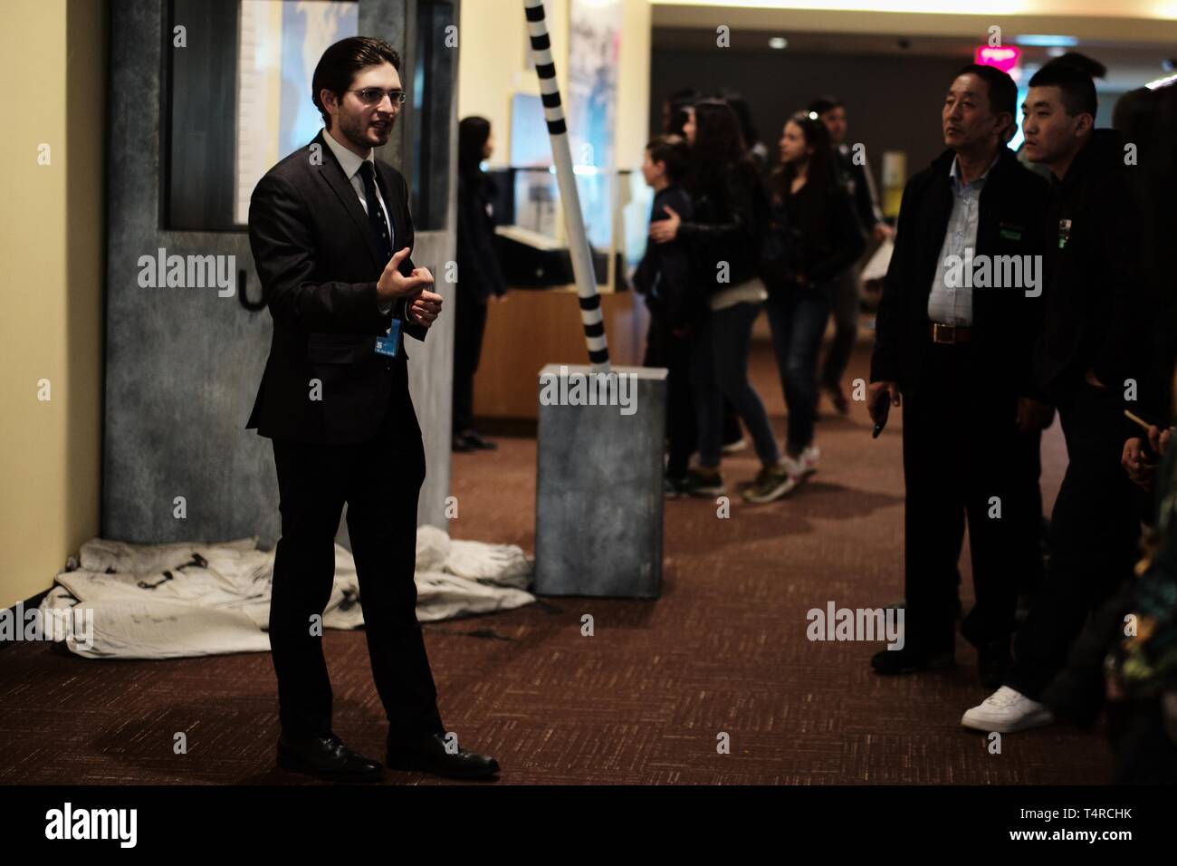 United Nations. 17th Apr, 2019. Oliver Marsh (L) speaks to tourists at ...