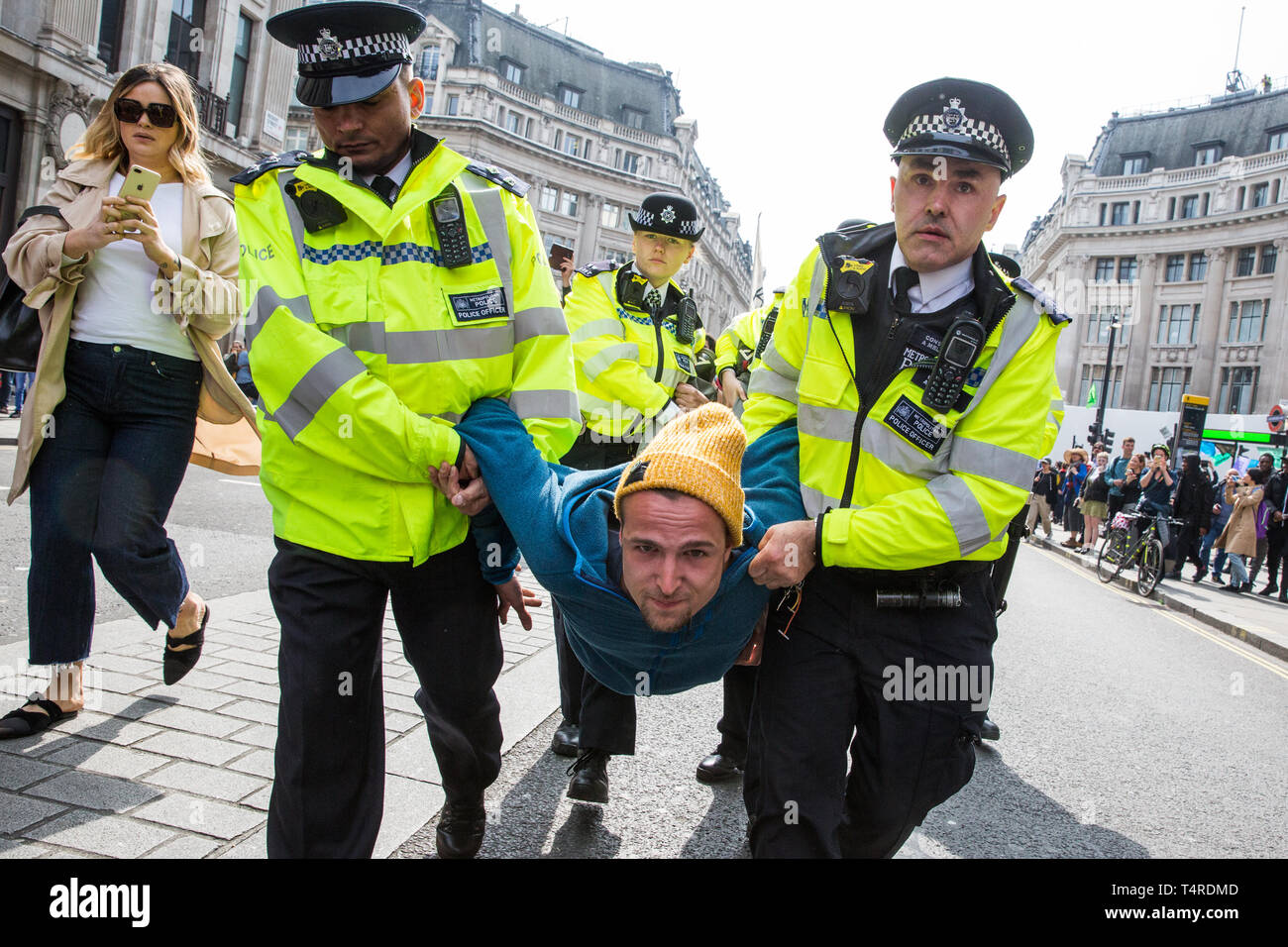London, UK. 18th April 2019. Police officers move in to arrest a ...