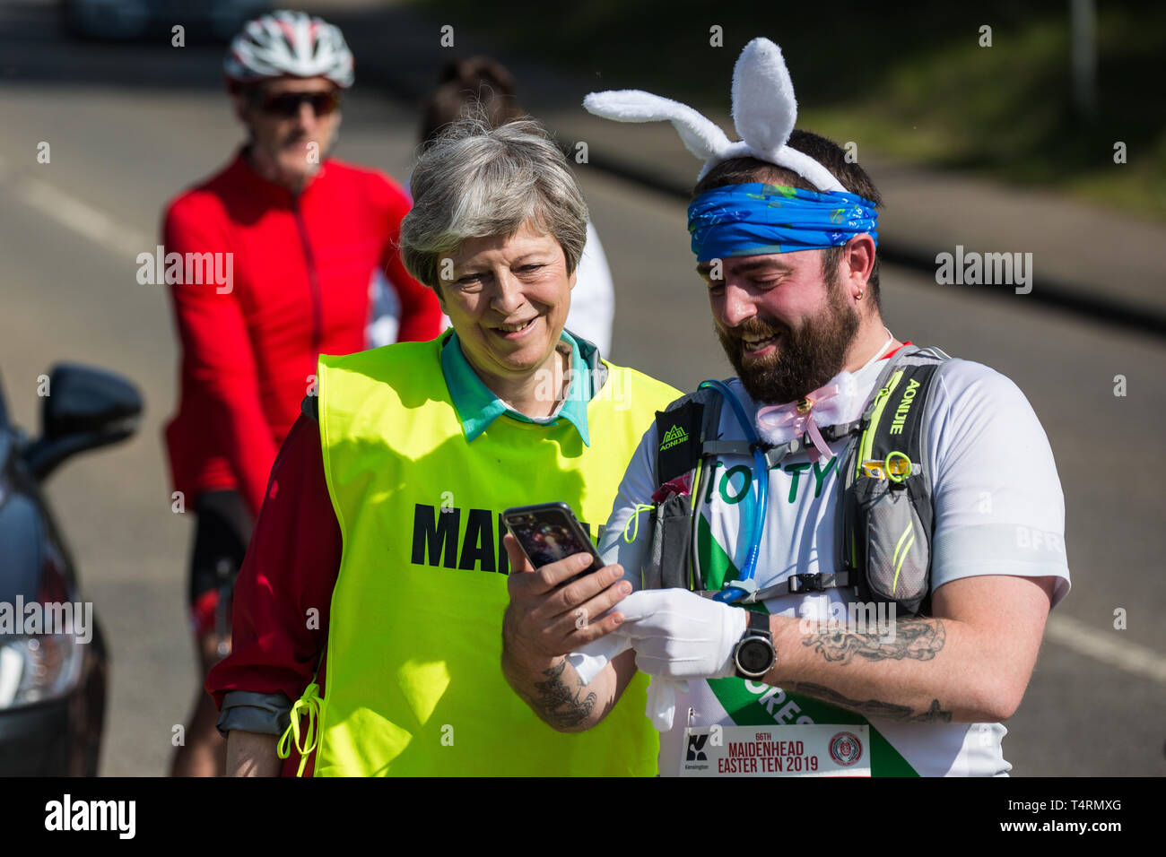 Maidenhead, UK. 19th April, 2019. A runner wearing rabbit ears takes a ...