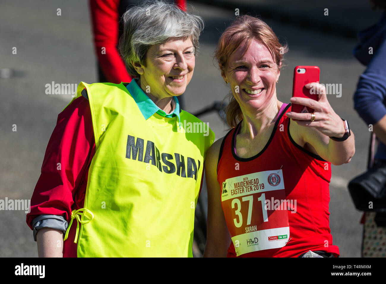 Maidenhead, UK. 19th April, 2019. A runner takes a selfie with Prime ...