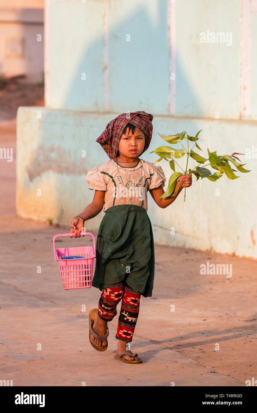Shan girl taking offerings to the Buddhist monastery in Pankam Village ...