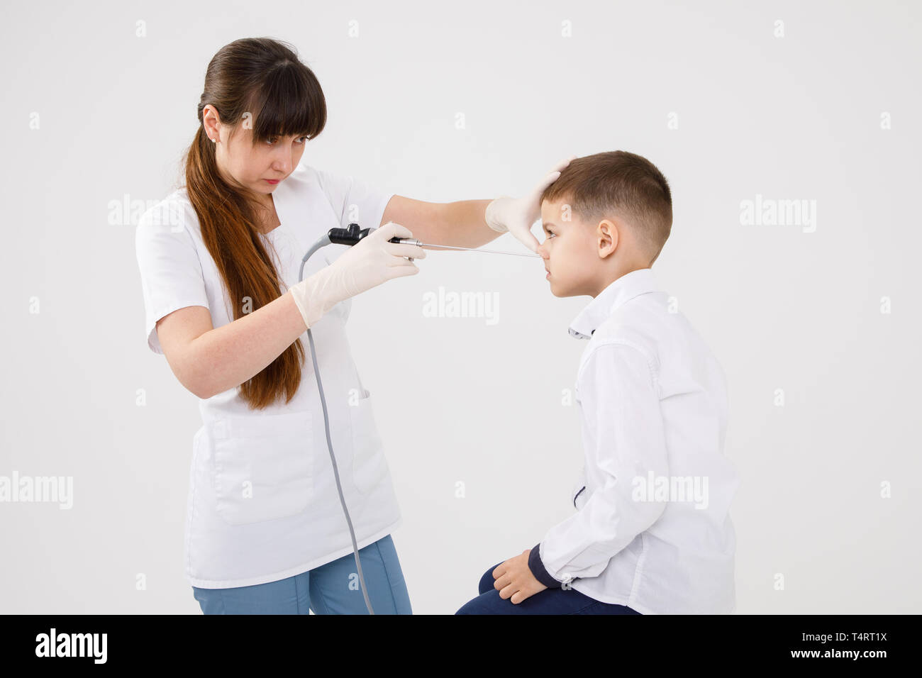Famale doctor checking nose of a male patient with the medical stick ...
