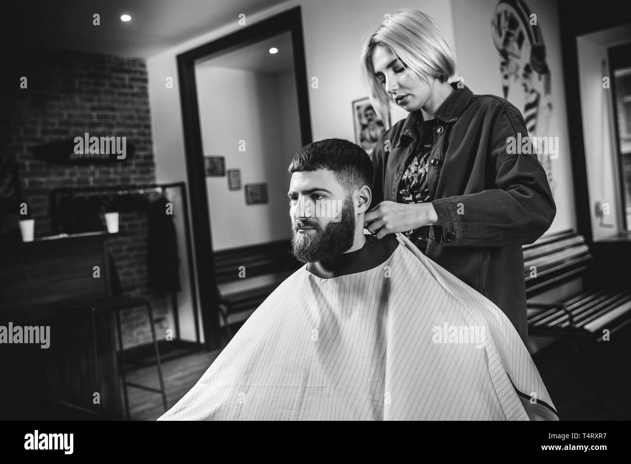Hairdresser making haircut man Black and White Stock Photos & Images ...
