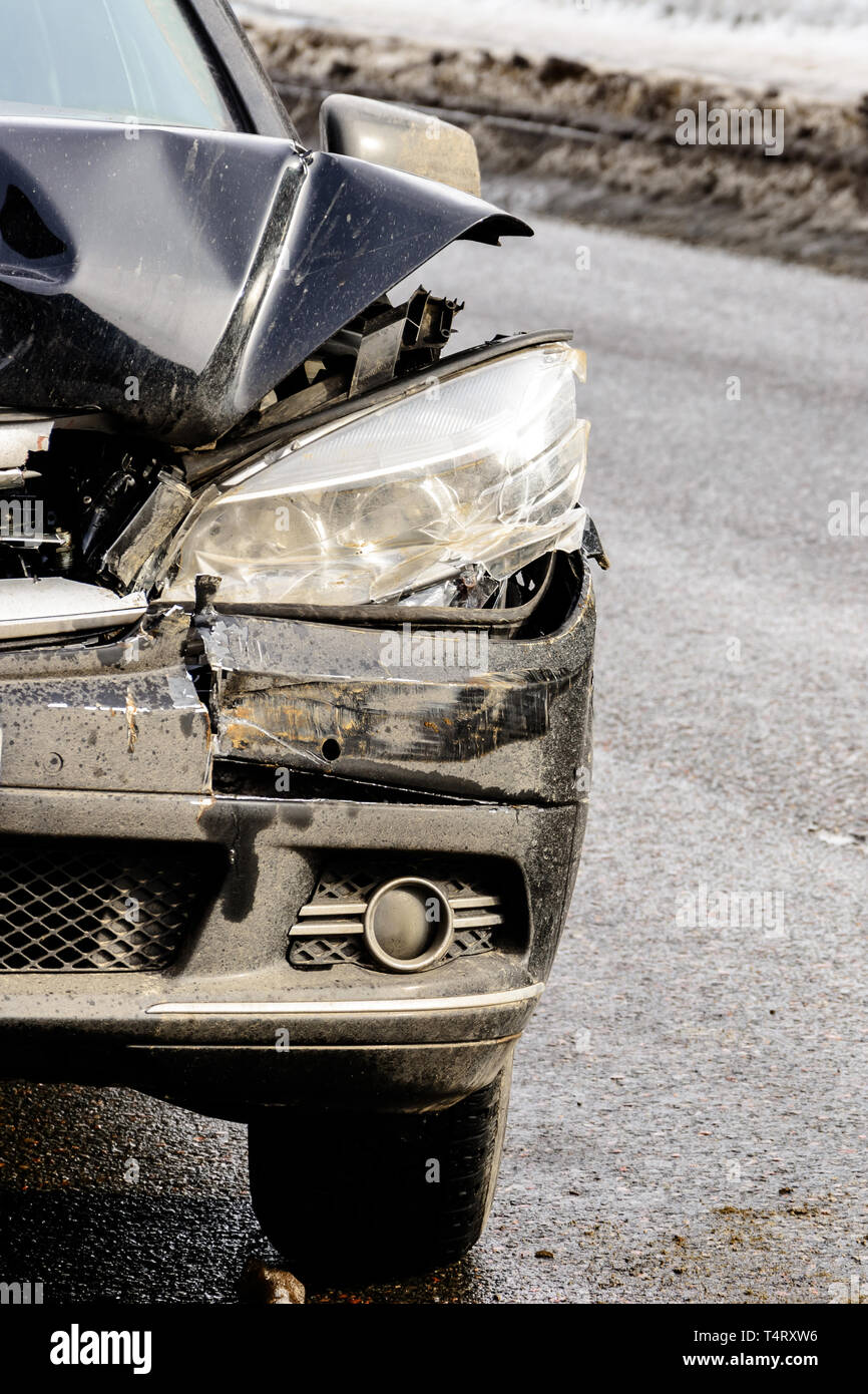 Broken car headlight on a black car, close-up, repair and replacement ...