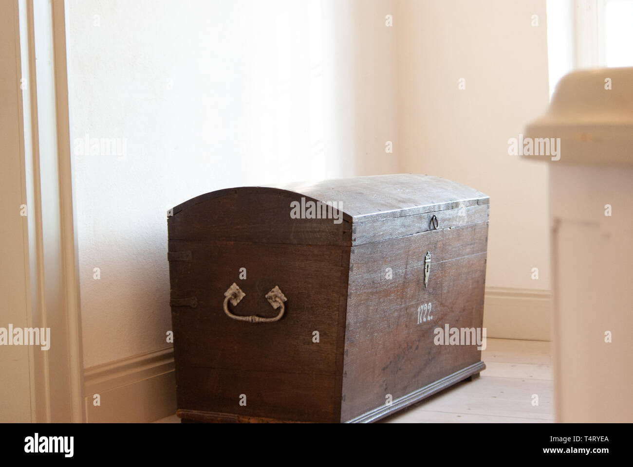 dark wooden chest on bright wooden floor in front of window Stock Photo ...