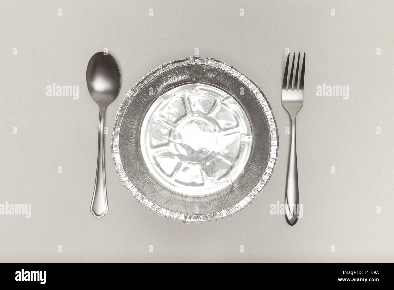 Spoon, fork and plate aluminum, top view Stock Photo - Alamy