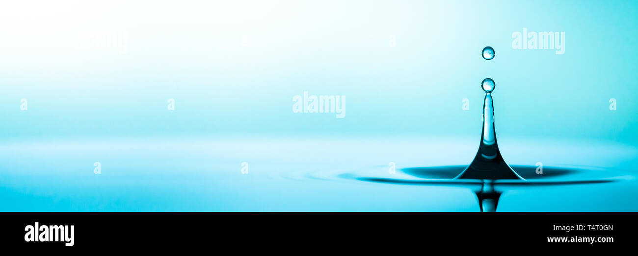 Clean Blue Water Droplet Splashing Into Puddle With Ripples Stock Photo ...