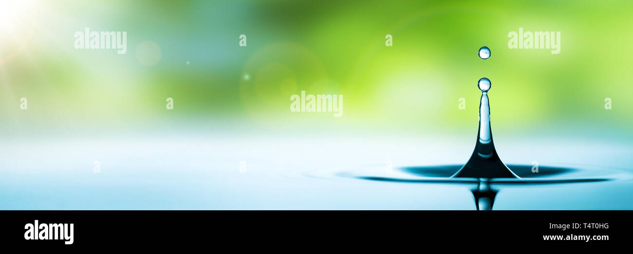 Clean Blue Water Droplet Splashing Into Puddle With Ripples Stock Photo ...