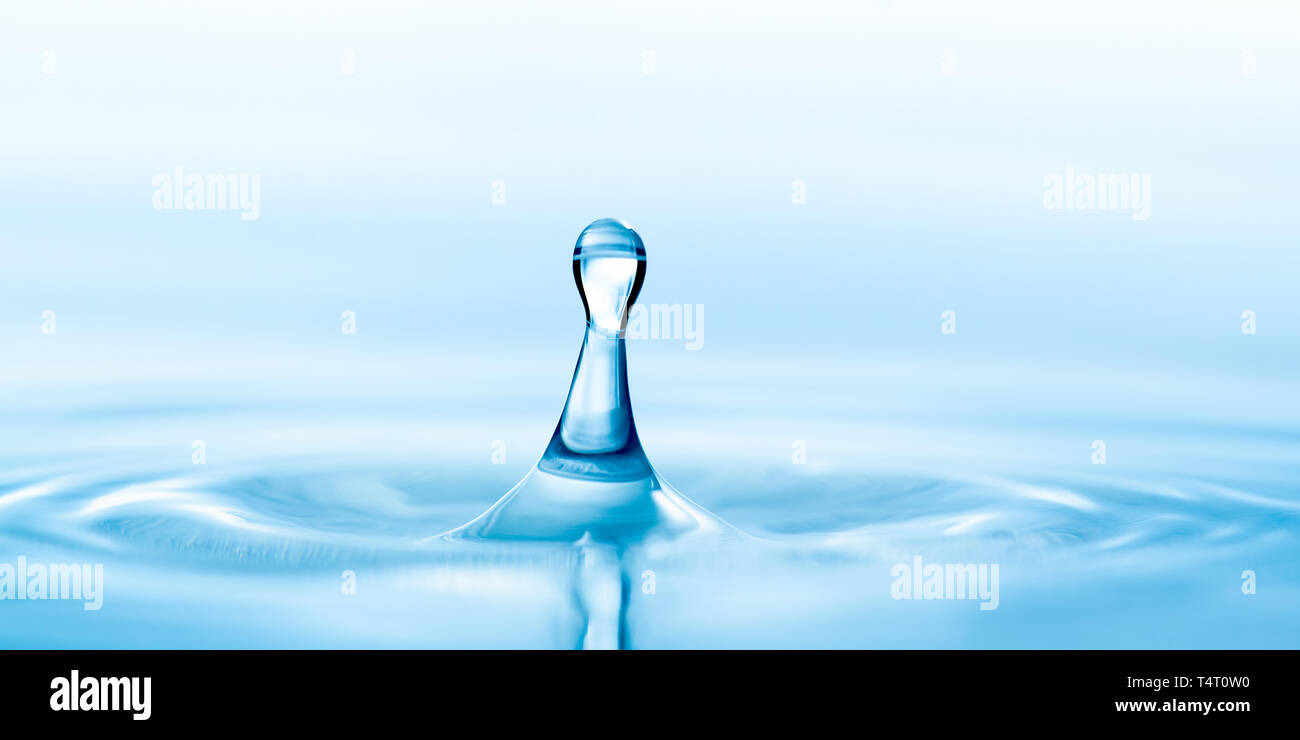 Clean Blue Water Droplet Splashing Into Puddle With Ripples Stock Photo ...