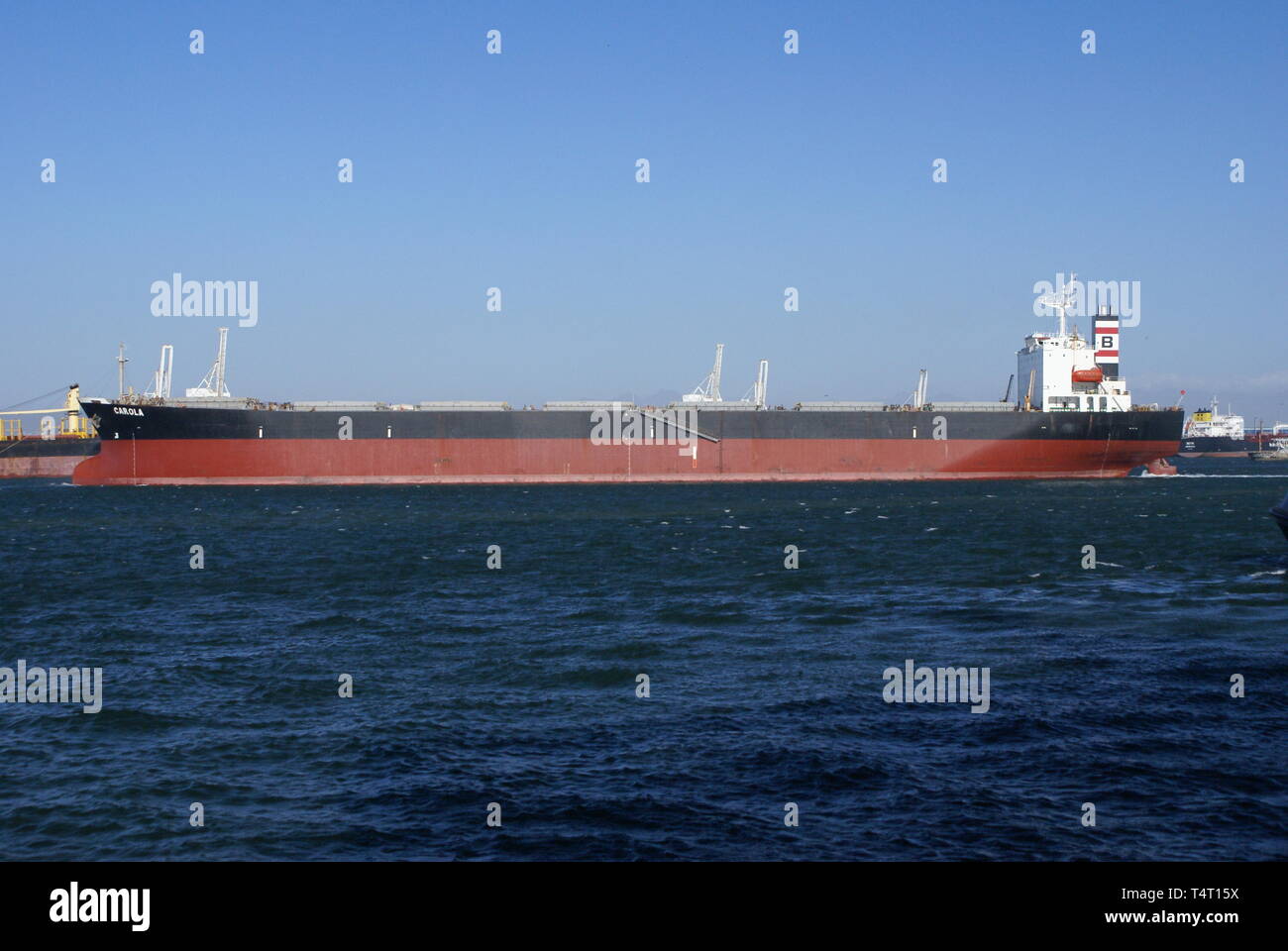 A bulk carrier Carola in the waters of Duncan Dock, port of Cape Town ...