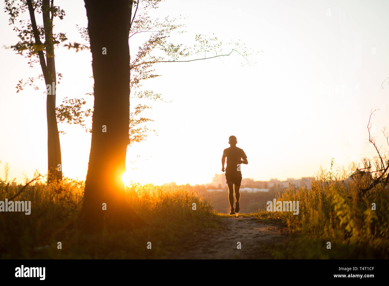 Sport running man in cross country trail run. Fit male runner exercise ...