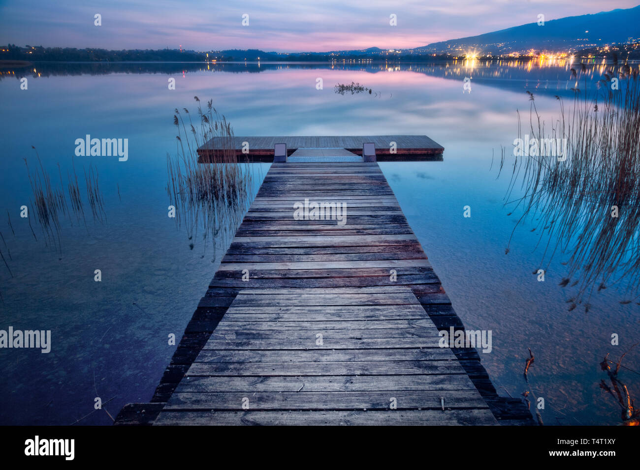 Wood bridge on a lake at sunset Stock Photo - Alamy