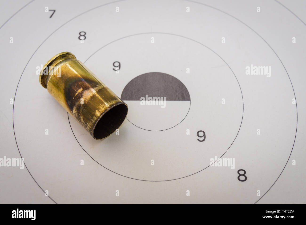 45 ACP bullet with a shooting target in the background Stock Photo - Alamy
