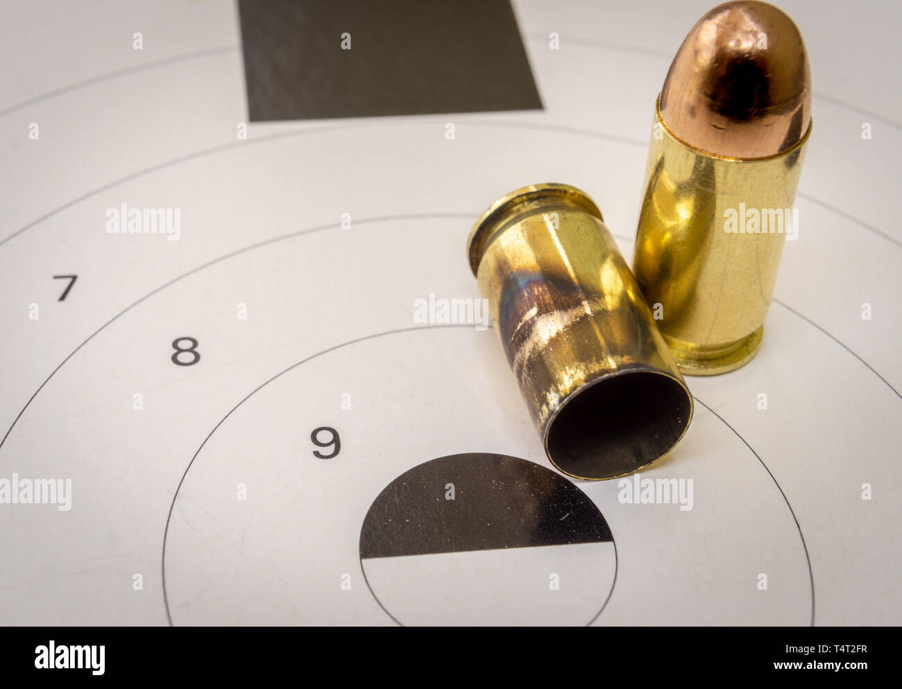 45 ACP bullet with a shooting target in the background Stock Photo - Alamy