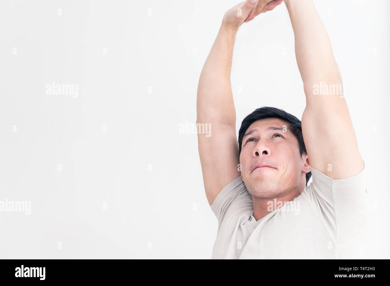 Asian male is stretching his arm out Stock Photo - Alamy