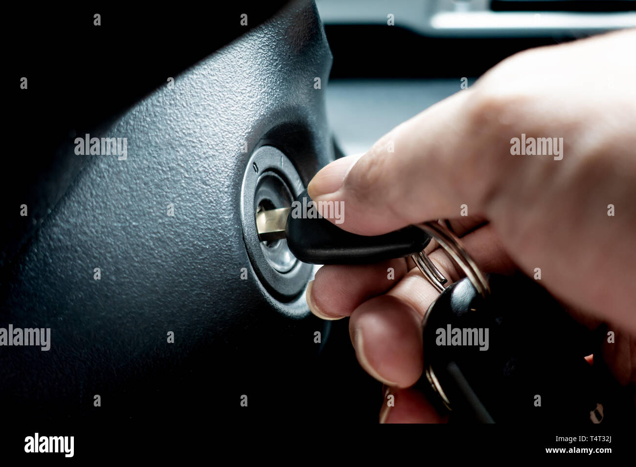 Hand turning car key in the key hole to start the car engine Stock ...