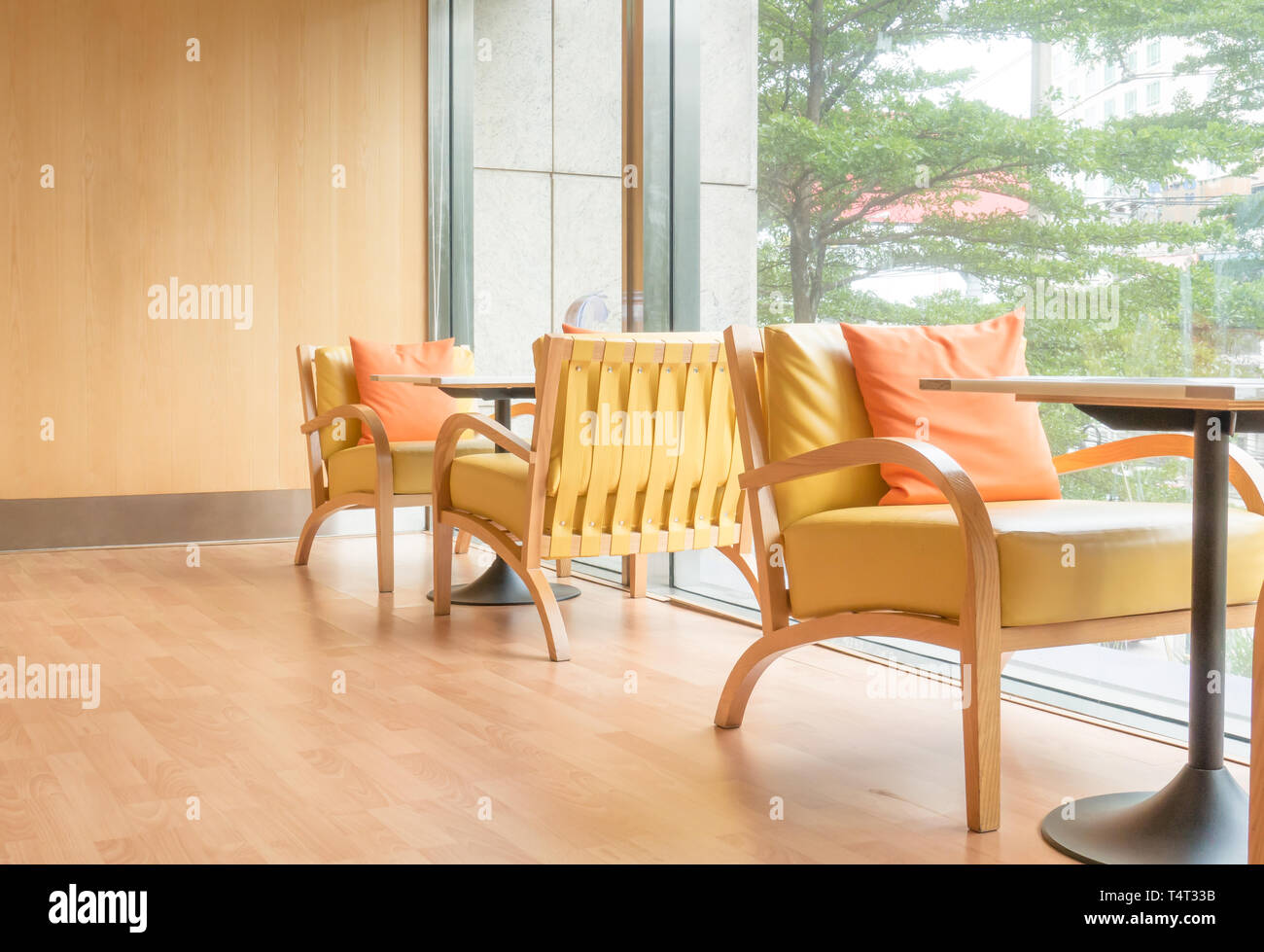 Orange tone bright cafe restaurant seating area Stock Photo - Alamy