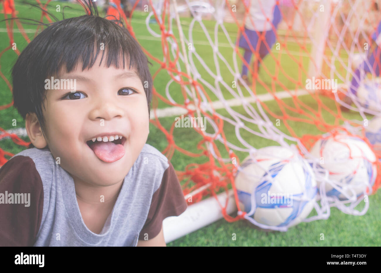 Happy Little boy behind the Goal in soccer training field Stock Photo ...