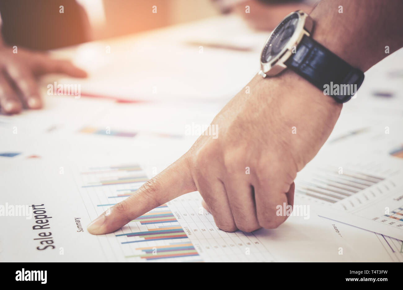 Hands pointing on data chart sheet for business meeting Stock Photo - Alamy