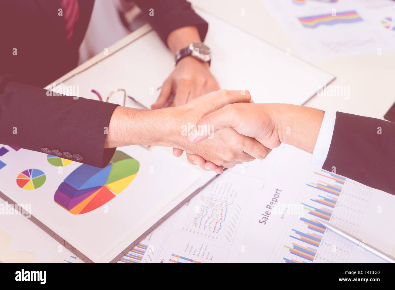 Business hand shake with Data Chart sheet on meeting table Stock Photo ...