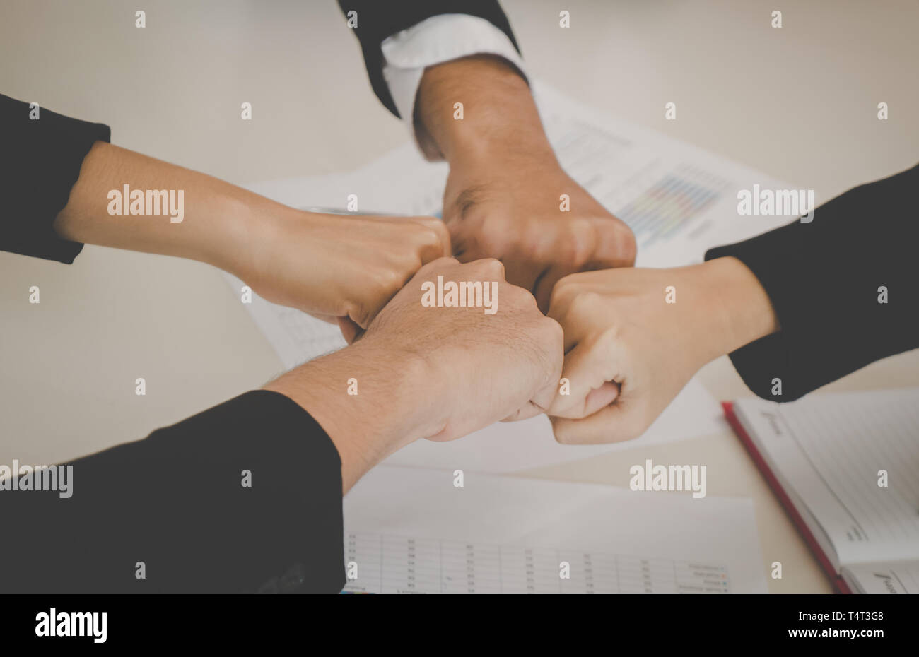 Four Fist bump in business meeting for team concept Stock Photo - Alamy