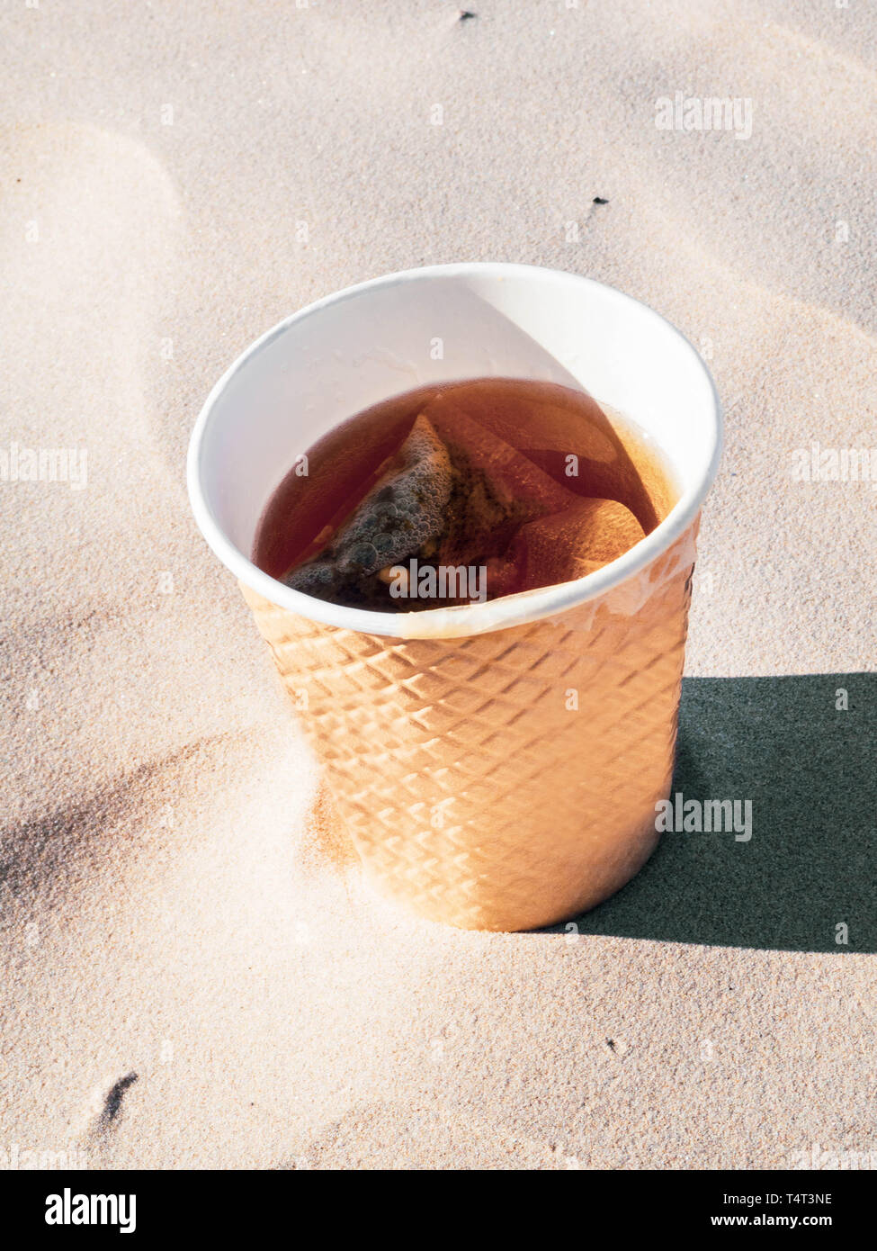 Take-out teacup with tea on sea sand background, outdoor Stock Photo ...