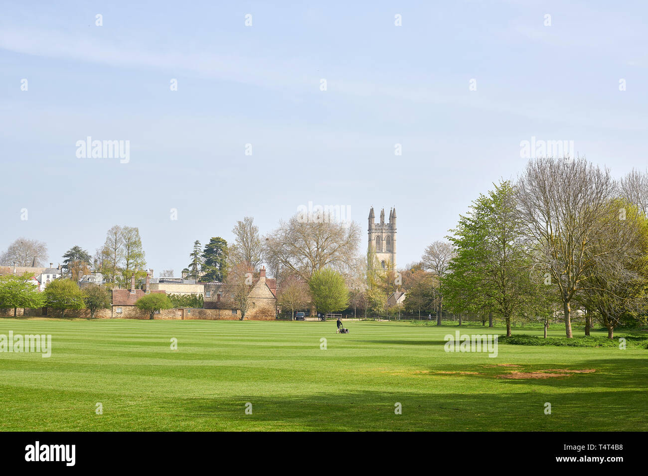 A gardener with his mower on Merton (aka Christ Church) field, with the ...