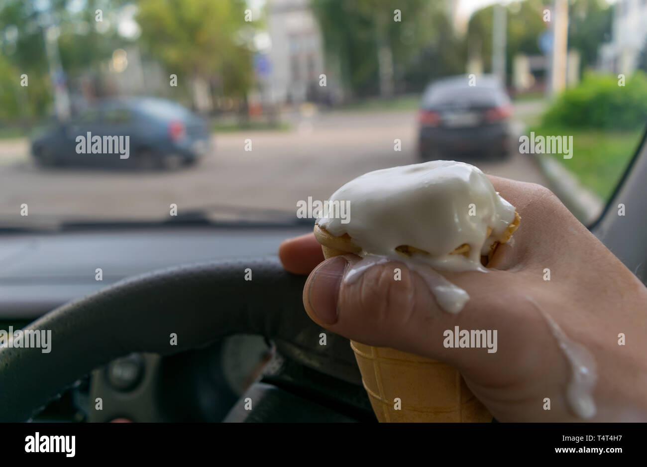 the driver holds the ice cream while driving a car Stock Photo - Alamy