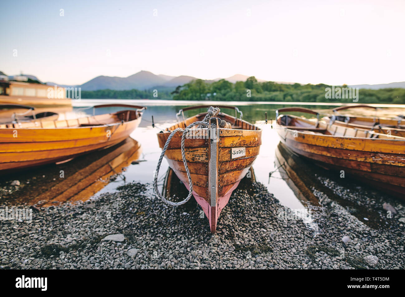 The iconic rowing boats on Derwent water In Keswick Cumbria at sunset ...