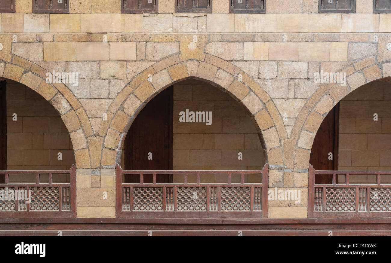 Front view of three arches with interleaved wooden balustrades at the ...