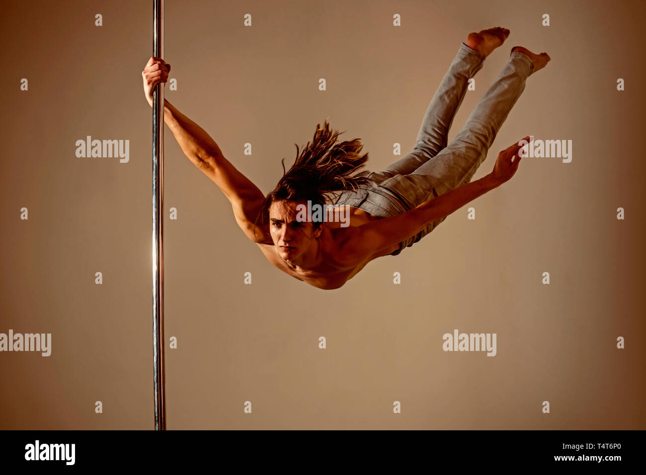dance studio. dance studio with man training on pylon Stock Photo - Alamy
