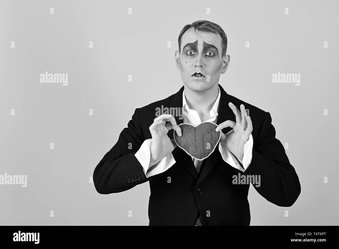 In love again and always. Mime man hold red heart for valentines day ...