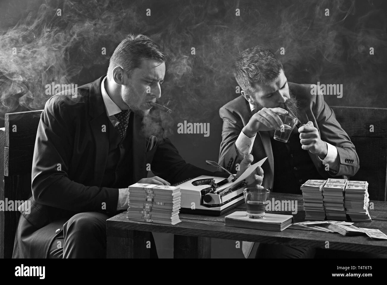 Working together. Businessmen write financial report while drinking and ...