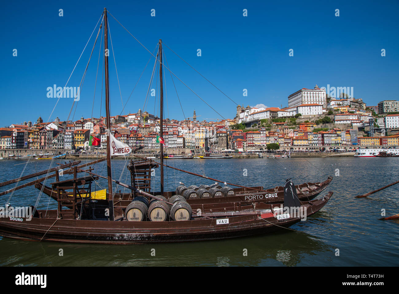 Rabelo boat with wine barrels on the Douro River, in front of Porto's ...