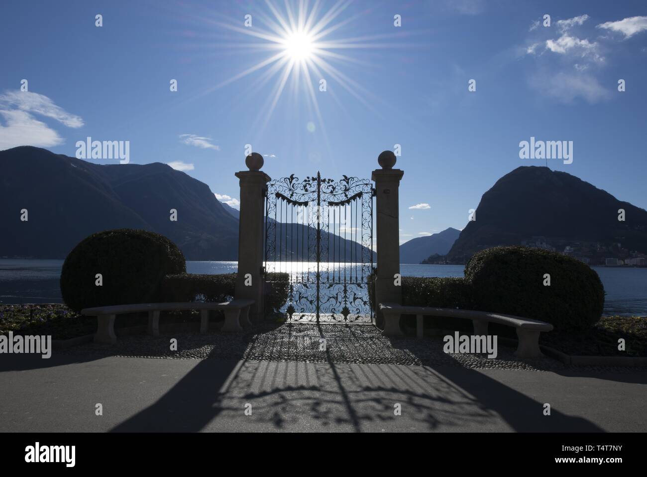 Gate on an alpine lake Lago Maggiore, backlit with sunbeam, Lugano ...