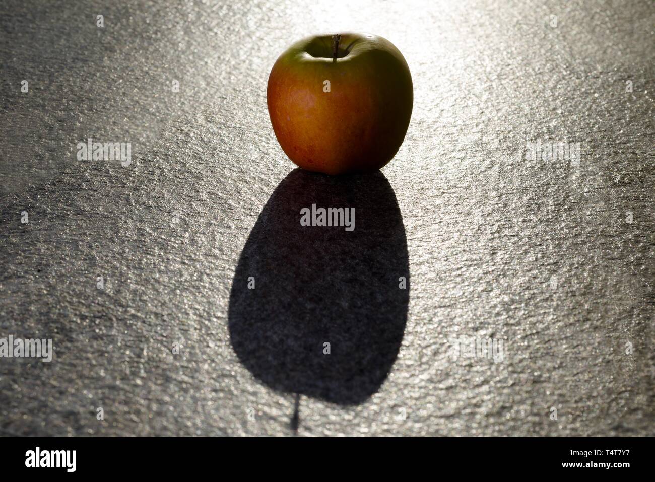 Apple with shadow Stock Photo - Alamy