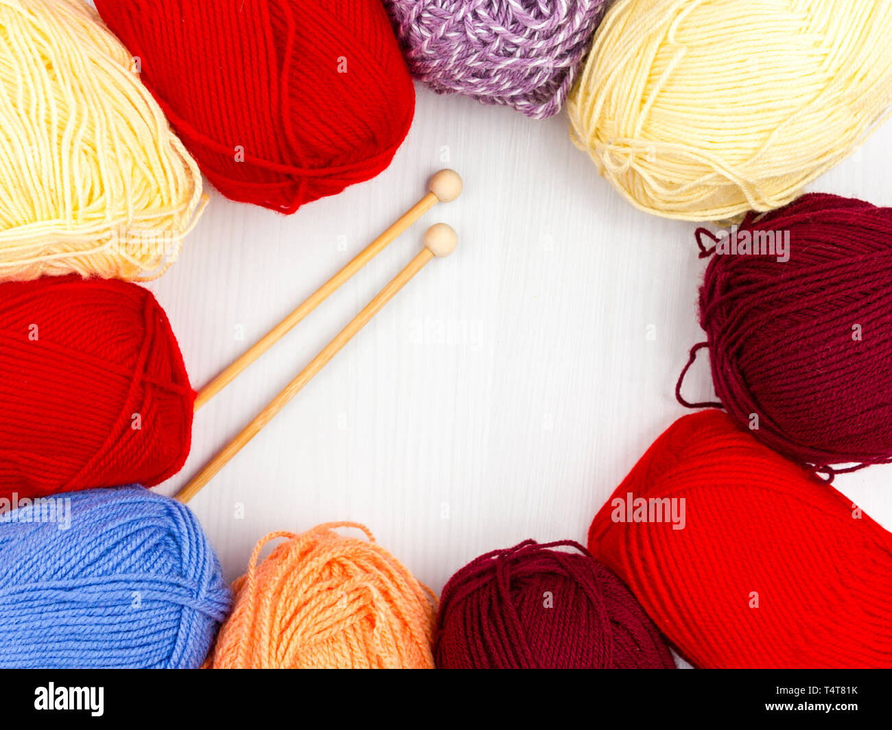 Flatlay of multicolored pastel knitting skeins of yarn and knitting ...